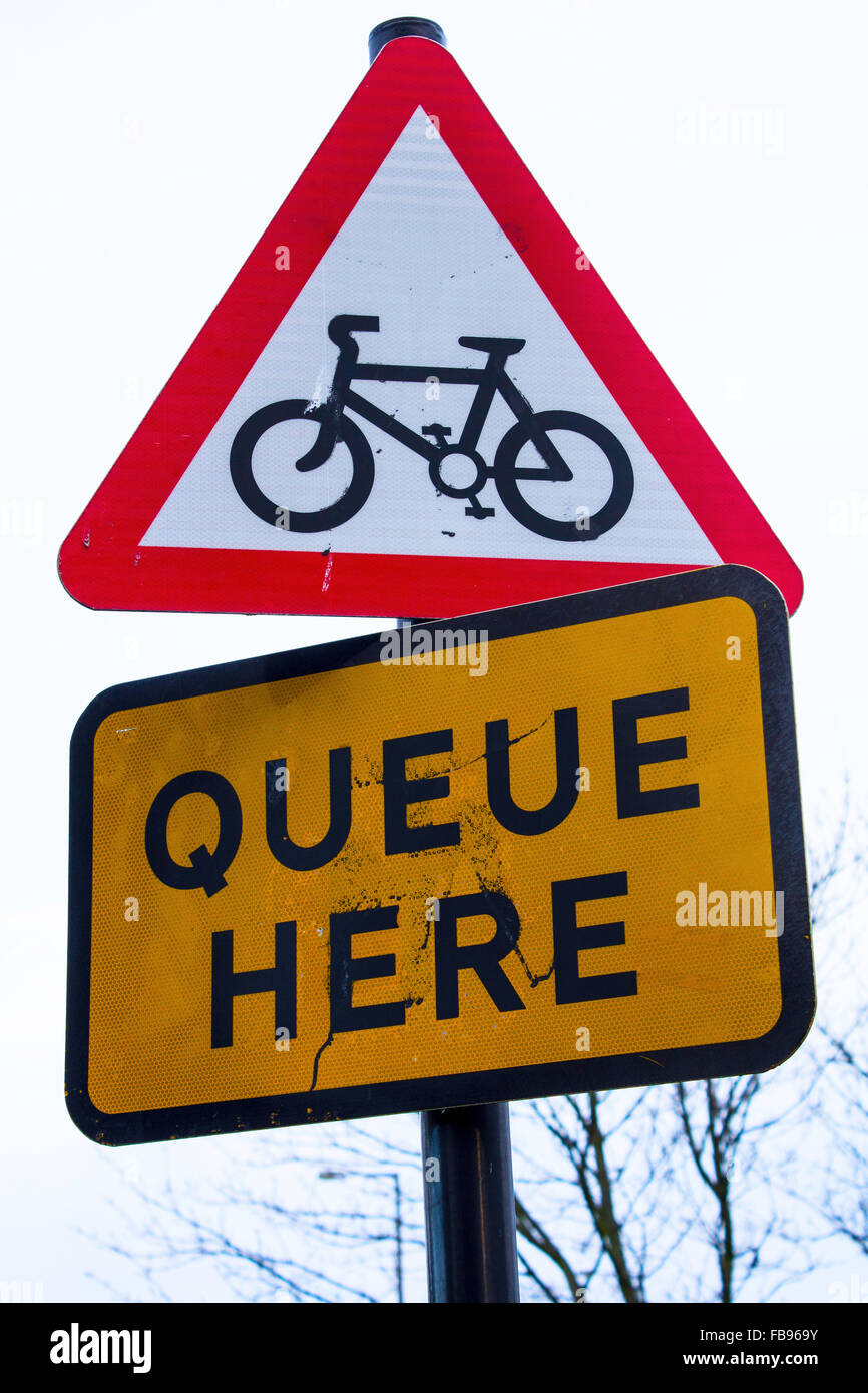Queue here sign hi-res stock photography and images - Alamy