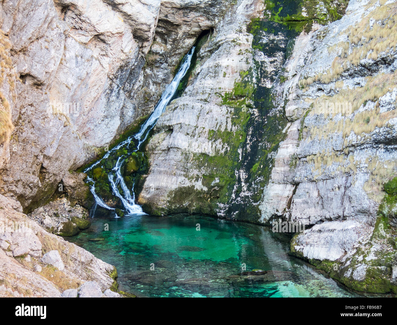 Small waterfall falling in lake Stock Photo - Alamy