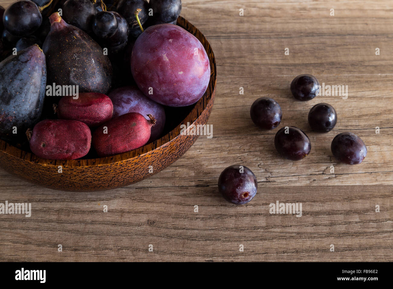 Purple fruit in a bowl Stock Photo - Alamy