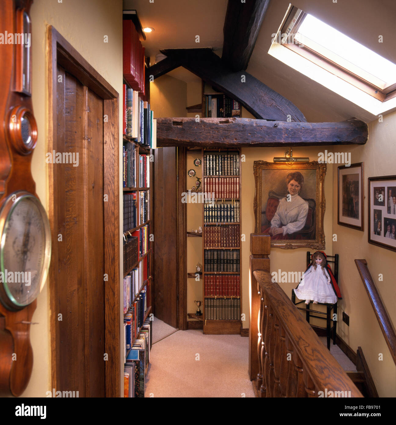 Narrow bookcase and lighted portrait on cottage landing with rustic ...