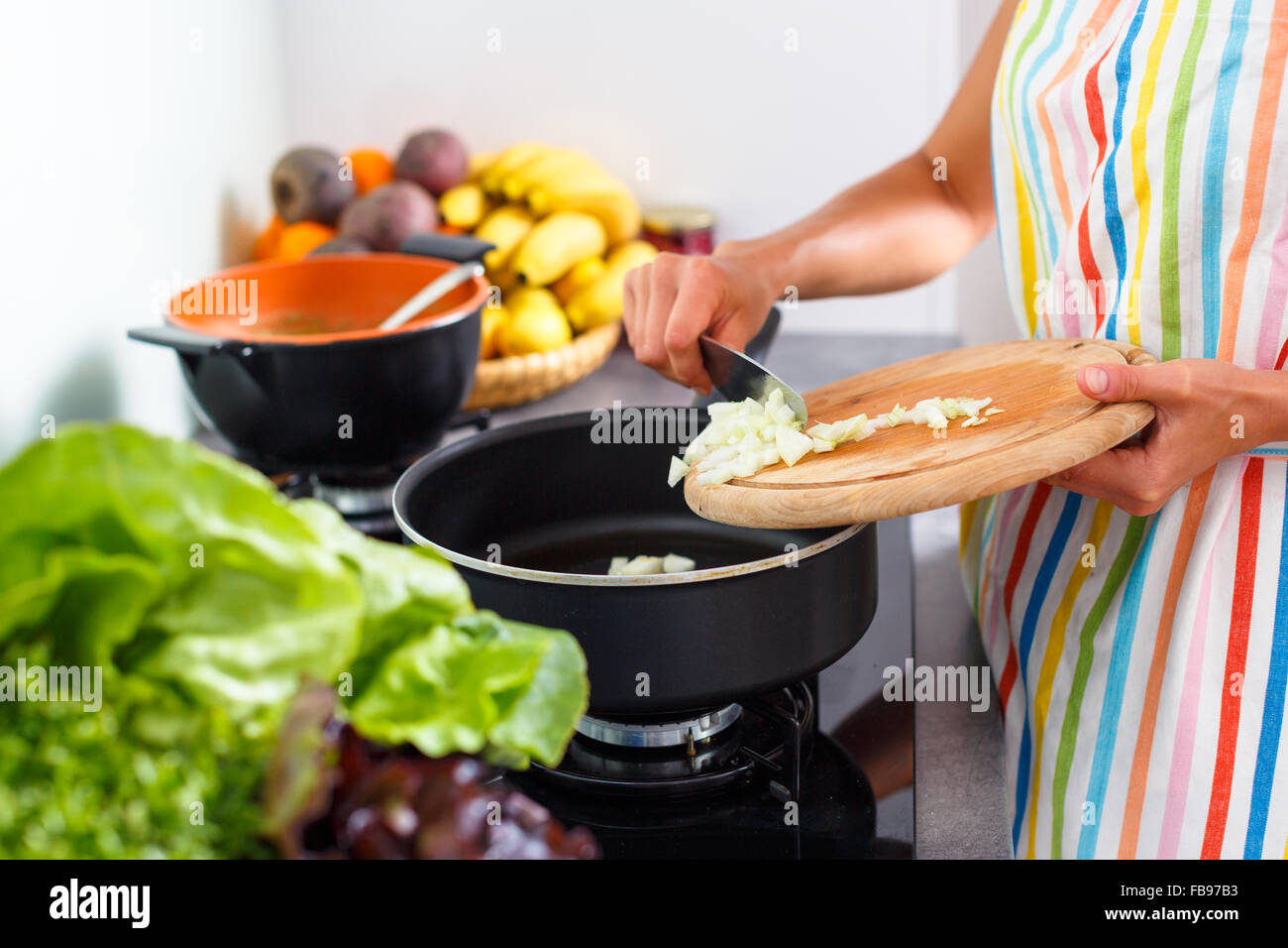 Young woman cooking in her modern kitchen Stock Photo - Alamy