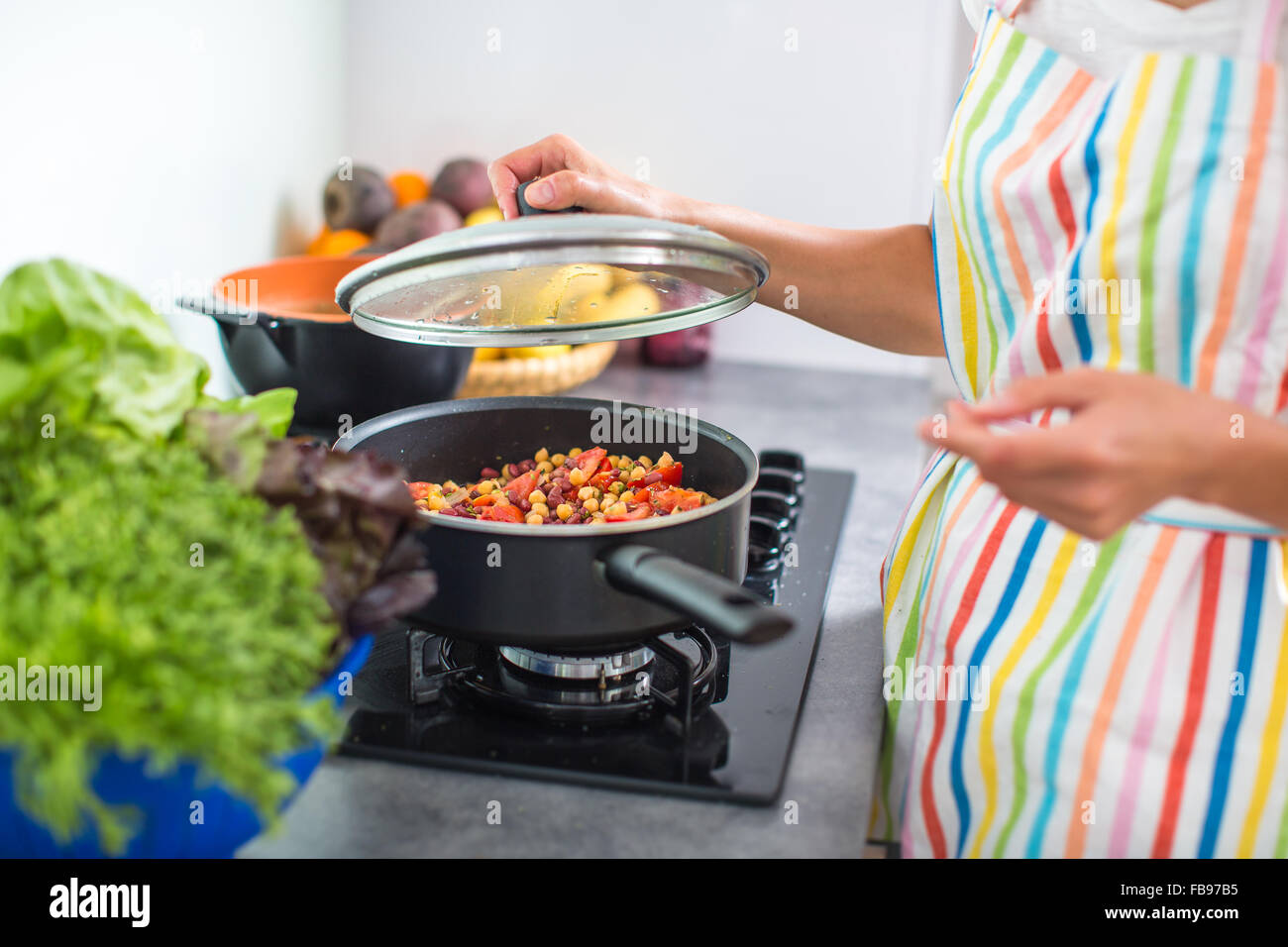 Young woman cooking in her modern kitchen Stock Photo - Alamy