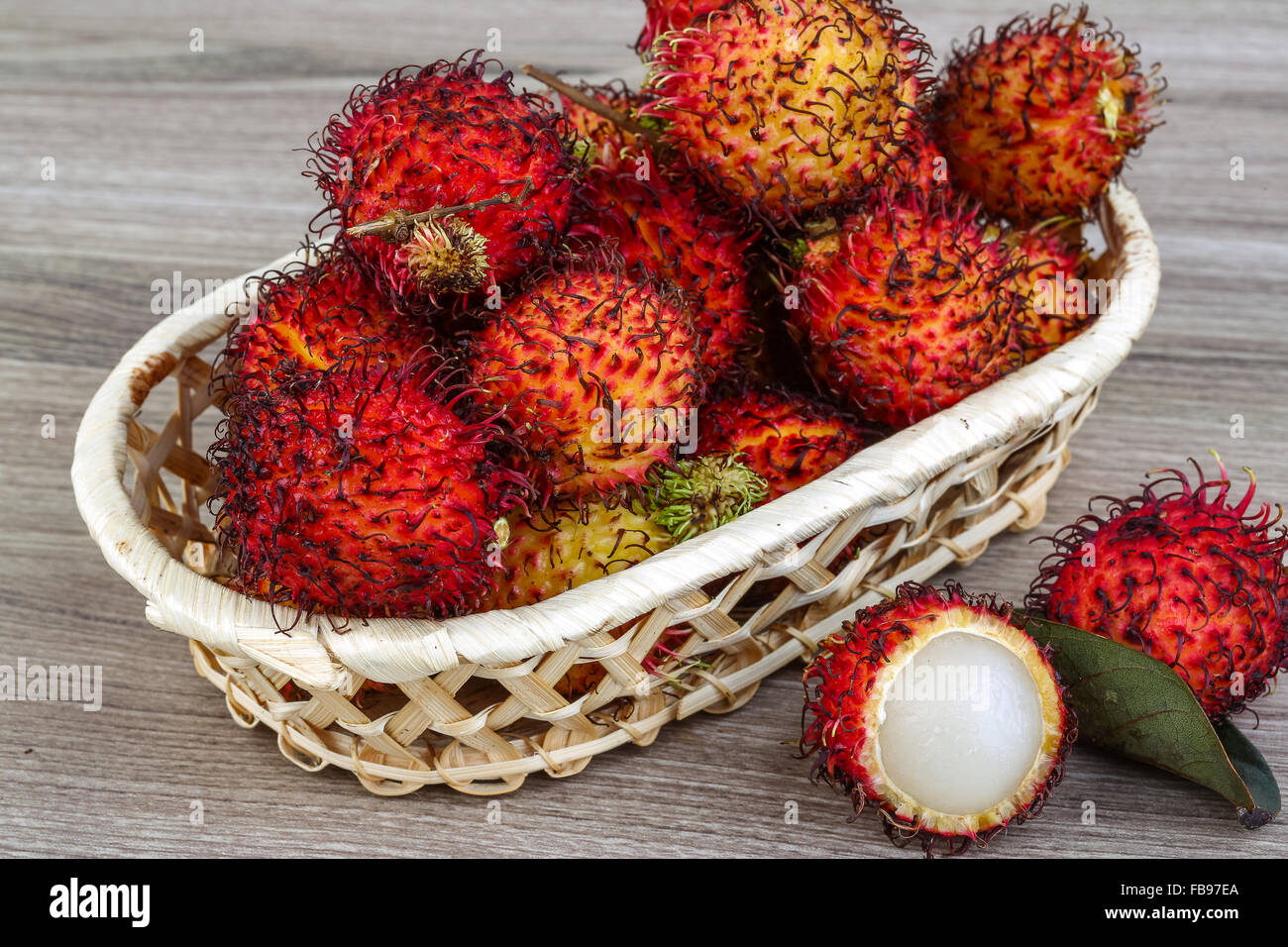 Asian fruit - rambutan - on the wood background Stock Photo - Alamy