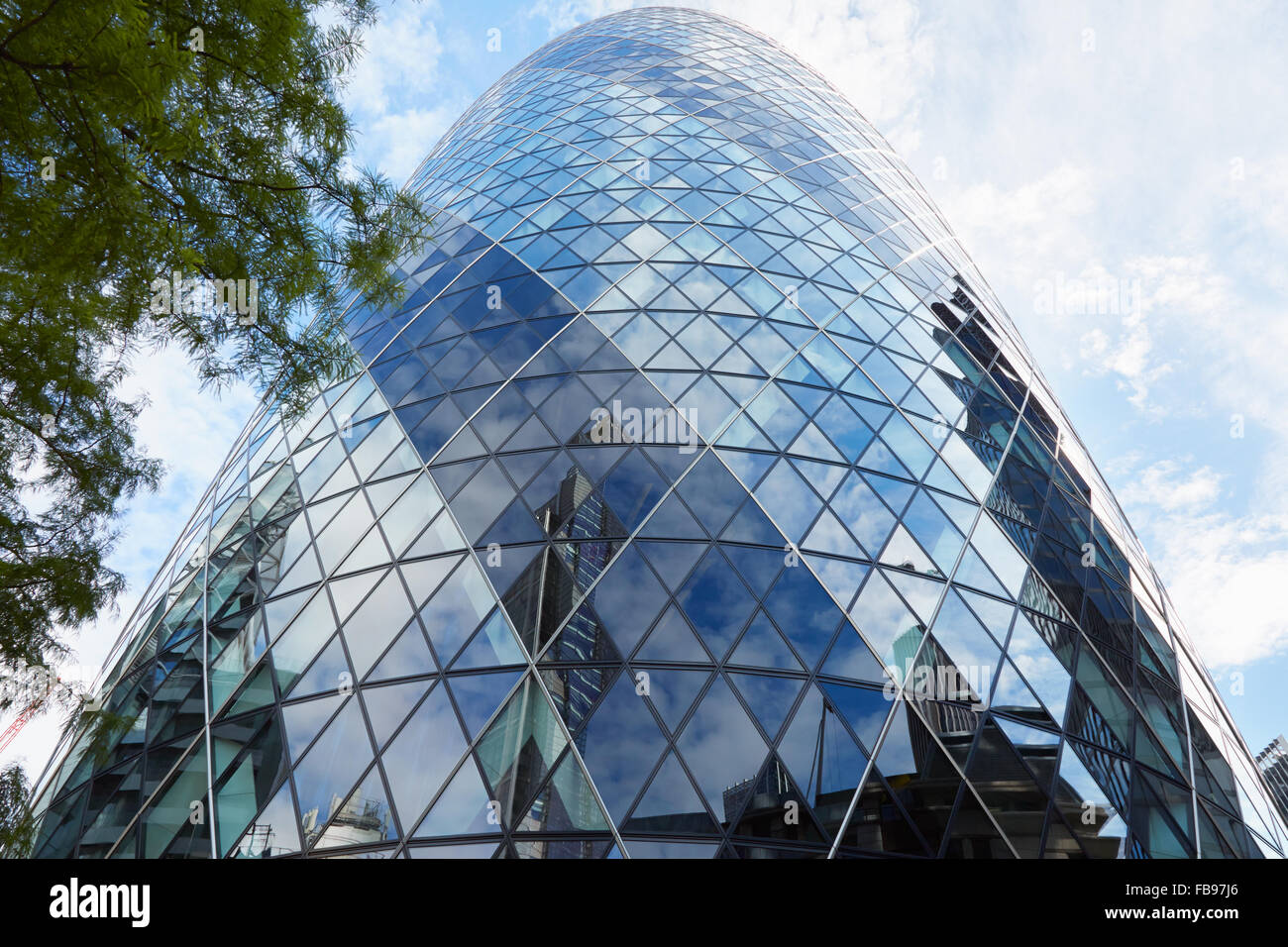 30 St Mary Axe building or Gherkin in the morning with tree in London ...