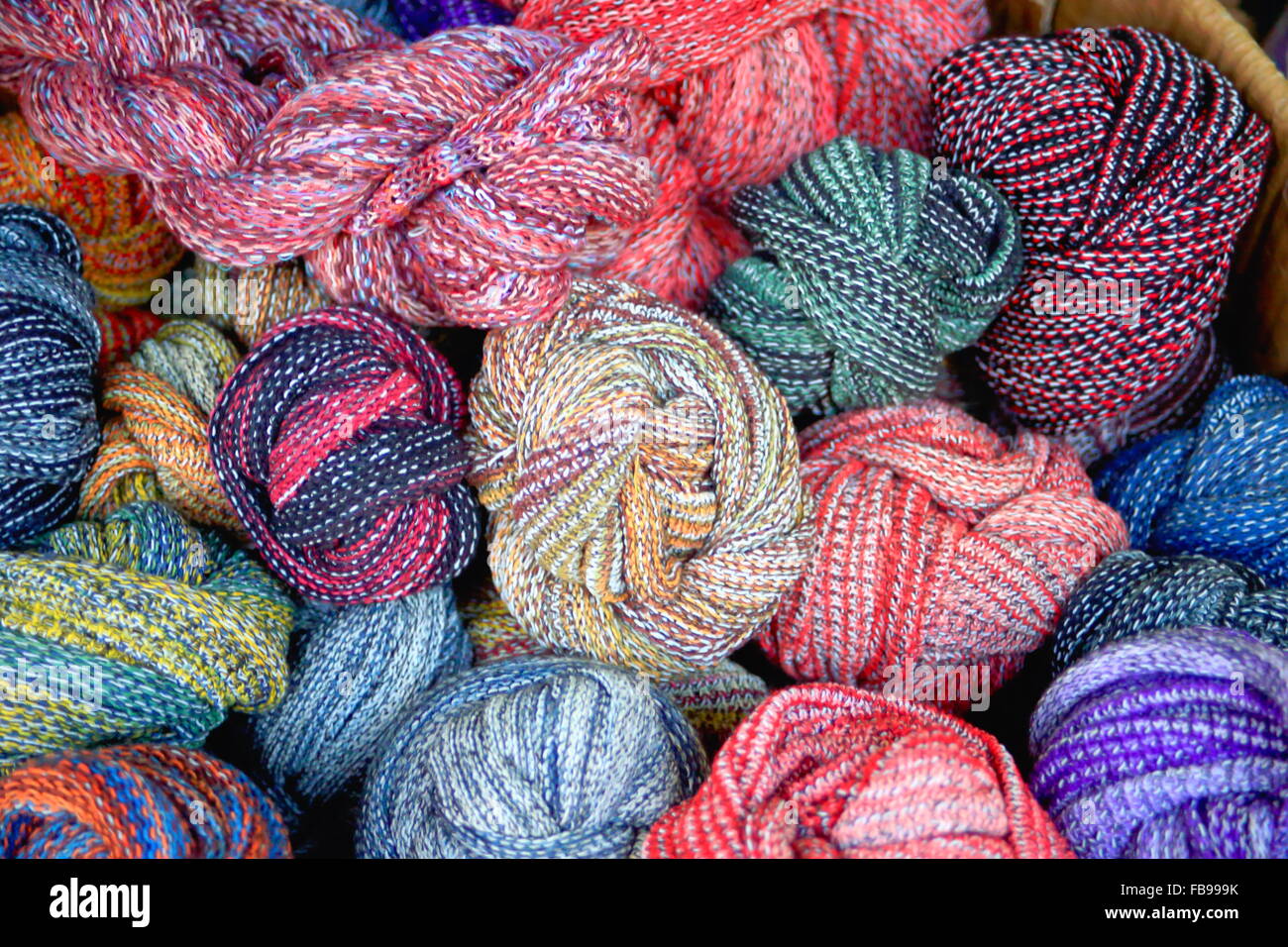 Heap of manycolored yak wool skeins piled in a box for sale in a ...
