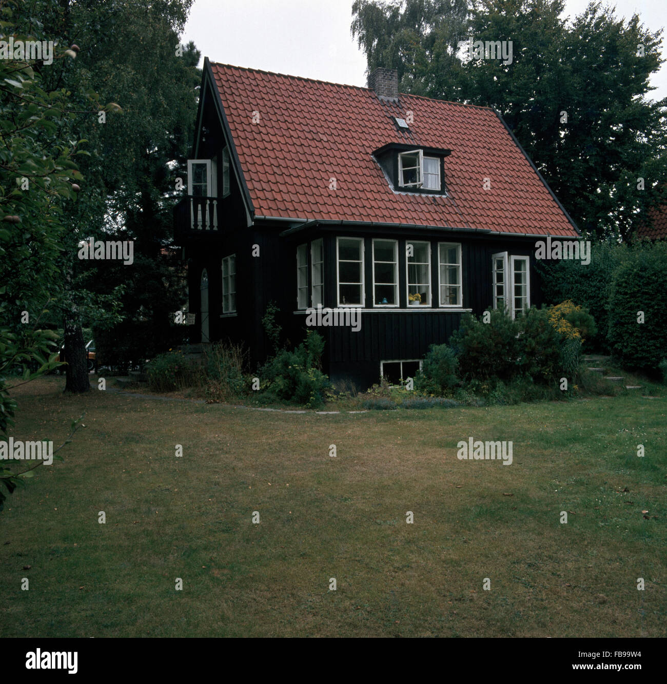 Exterior of a traditional single storey Swedish country cottage with a ...