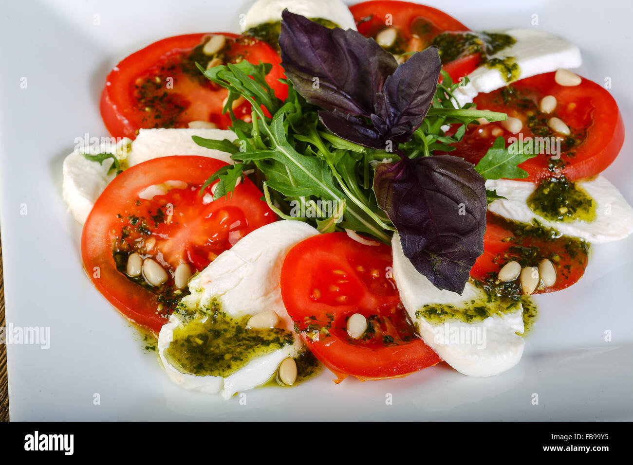 Italian traditional Caprese salad with cedar nuts Stock Photo - Alamy