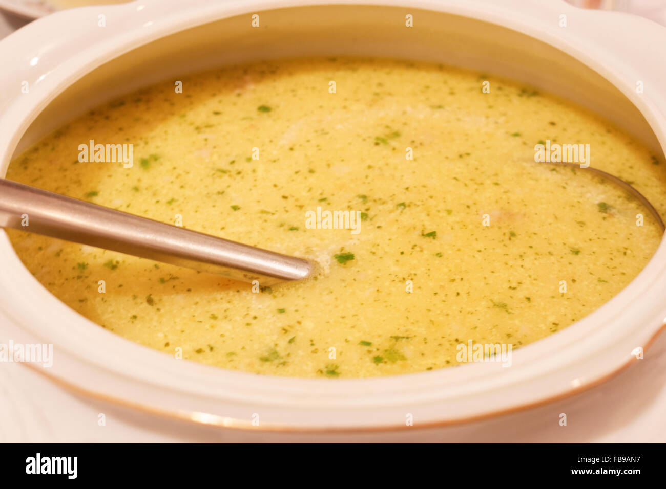 Yellow cream meat soup with spice and vegetables Stock Photo - Alamy