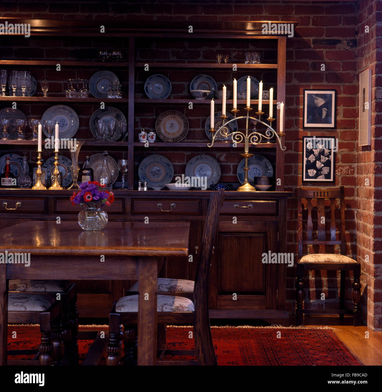 Brass candelabra on dark wood dresser in nineties dining room Stock ...