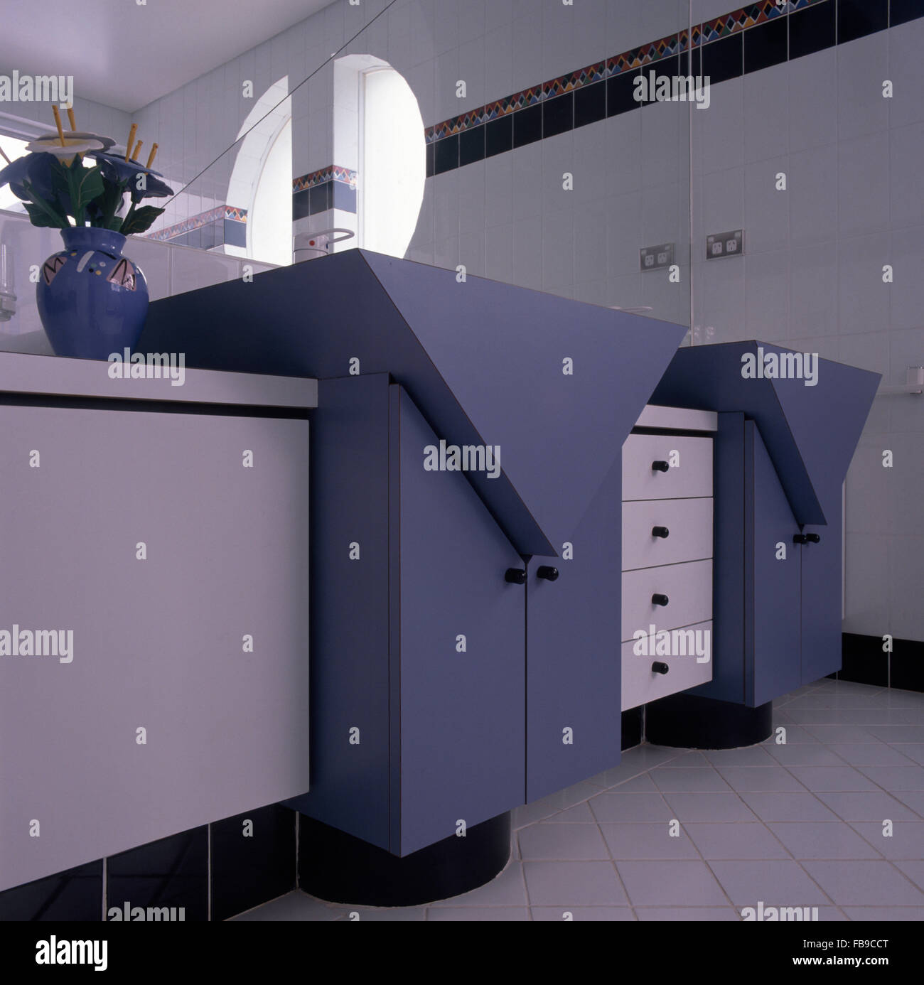 Angular blue vanity unit in nineties bathroom Stock Photo - Alamy