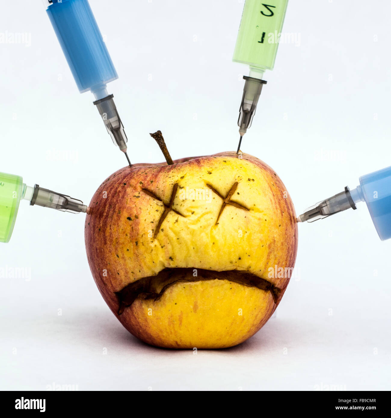 Sad apple with syringes Stock Photo - Alamy