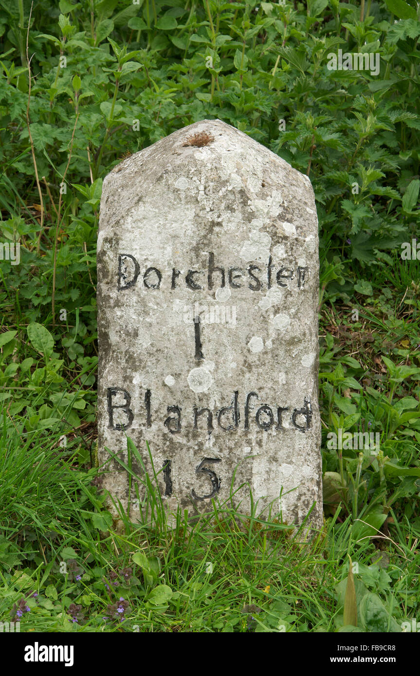 An ancient roadside milestone indicating a distance of one mile from ...