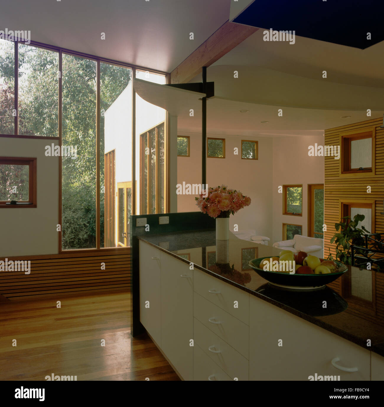 Bowl of fruit on fitted sideboard in a large open plan architectural ...