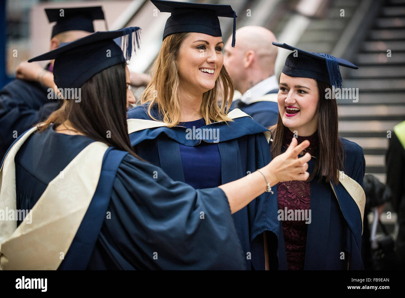 Three happy, smiling young women graduands, university graduation ...