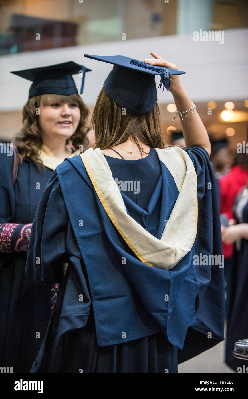 Young female graduand holding hat on, graduation ceremony, UK Stock ...