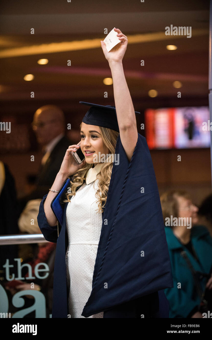 Happy, smiling young female graduand signals attention, university ...