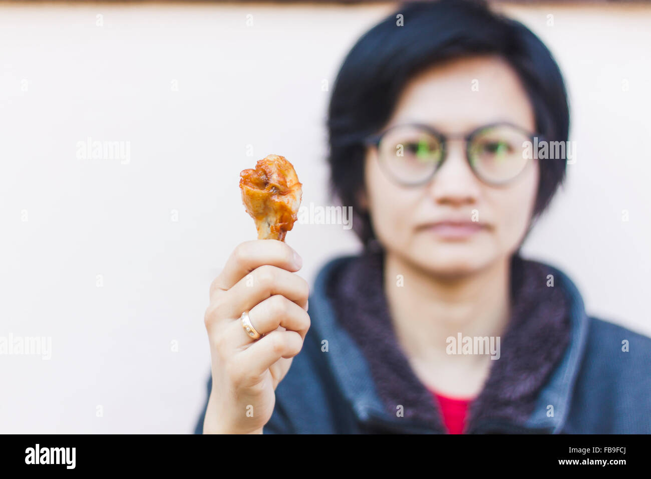 Hand holding grilled chicken wing, stock photo Stock Photo - Alamy