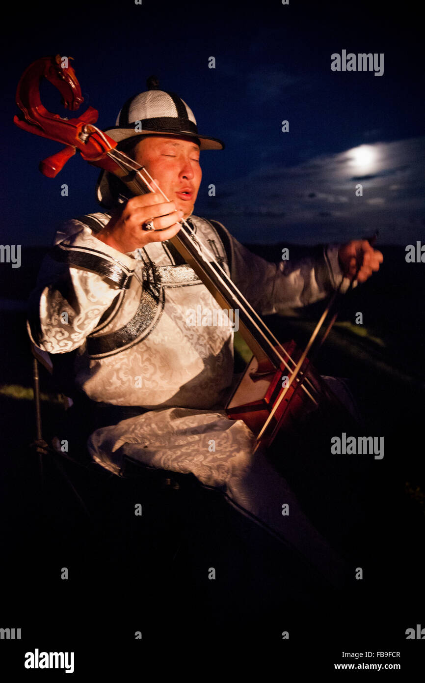 A horse hair fiddler and throat singer conveys the rhythms of horses ...