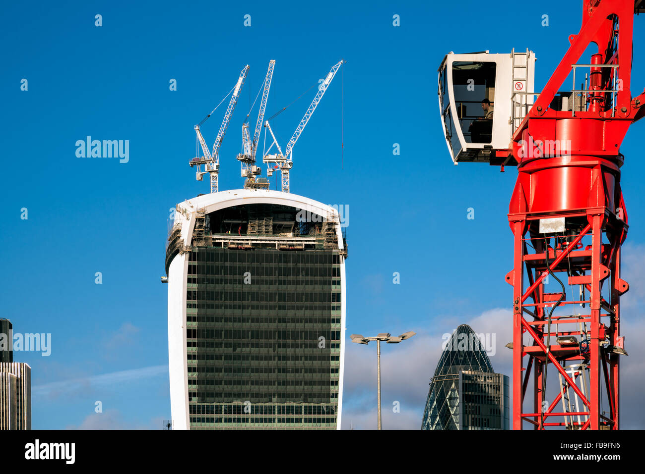 Red crane operating in London Stock Photo - Alamy