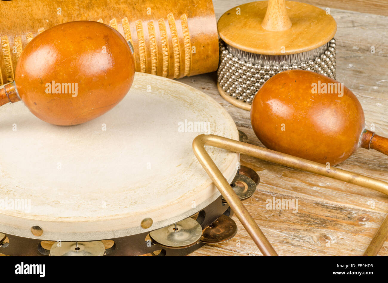 Traditional small p'ercussion instruments in a still life on a rustic ...
