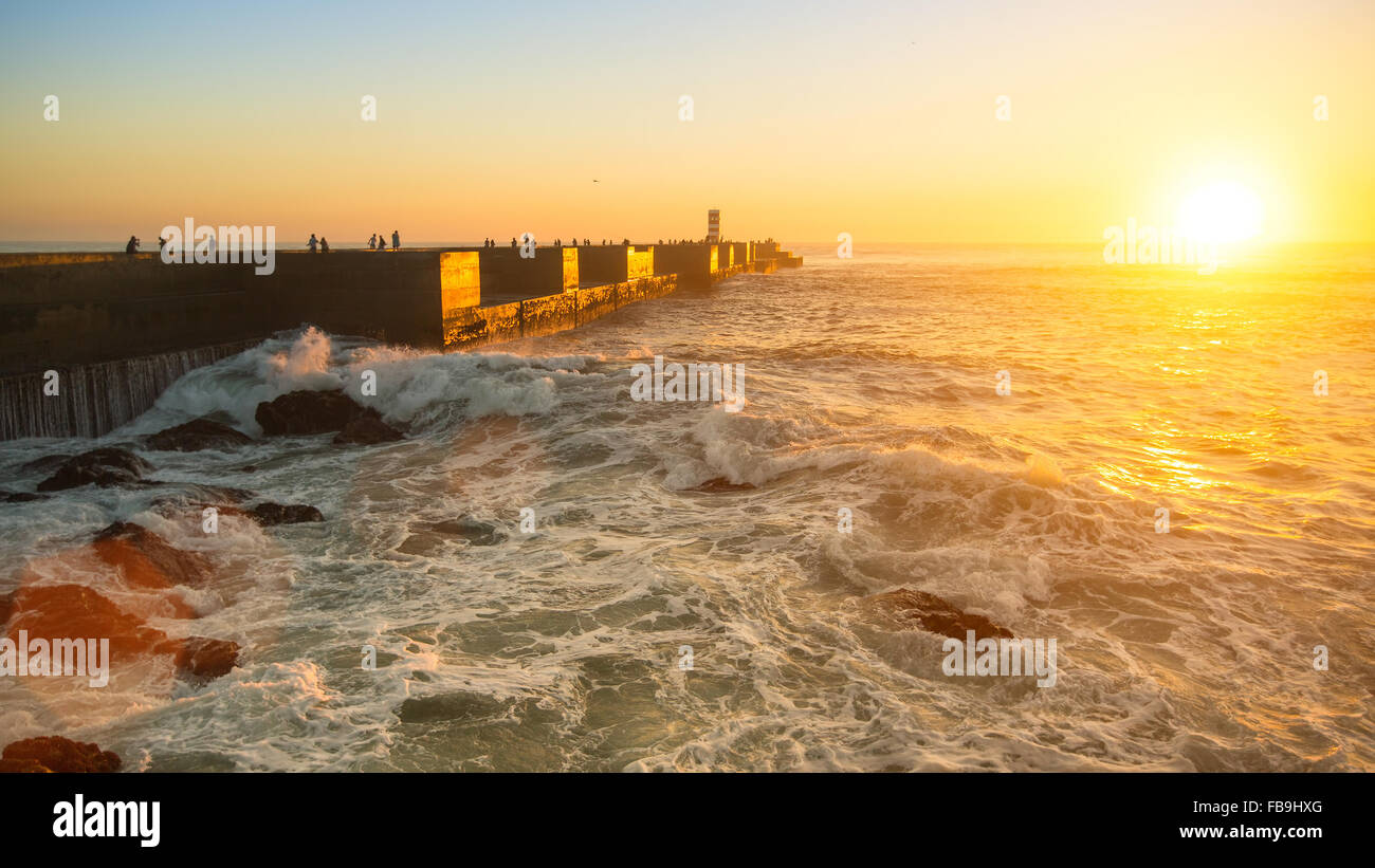 Ocean coast and stone pier during stunning sunset Stock Photo - Alamy