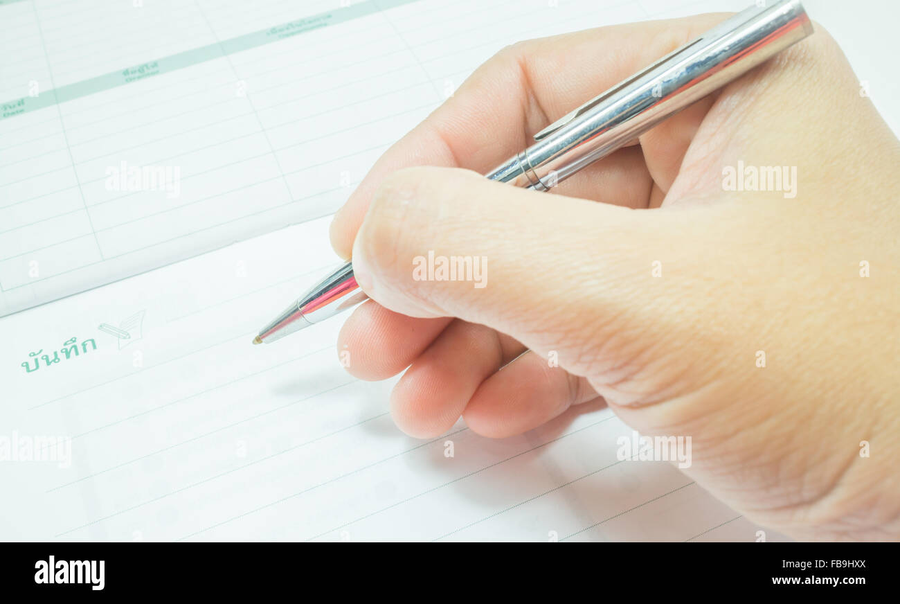 Hand on metallic pen write on the paper, stock photo Stock Photo - Alamy