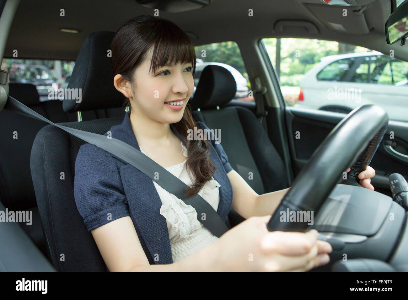 Young woman driving a car Stock Photo - Alamy