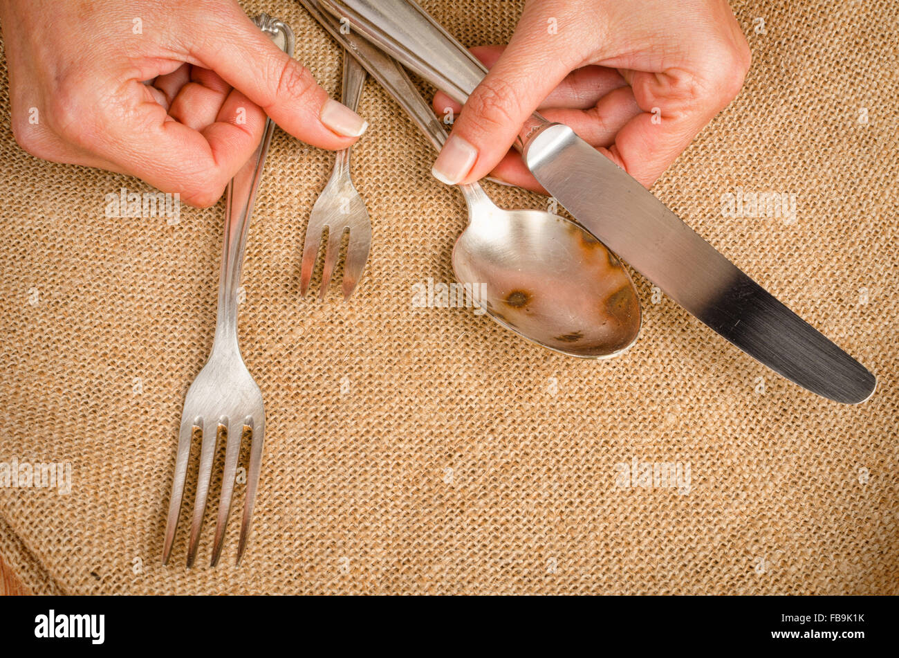 Female hands holding stained silverware in dear need for a polish Stock ...