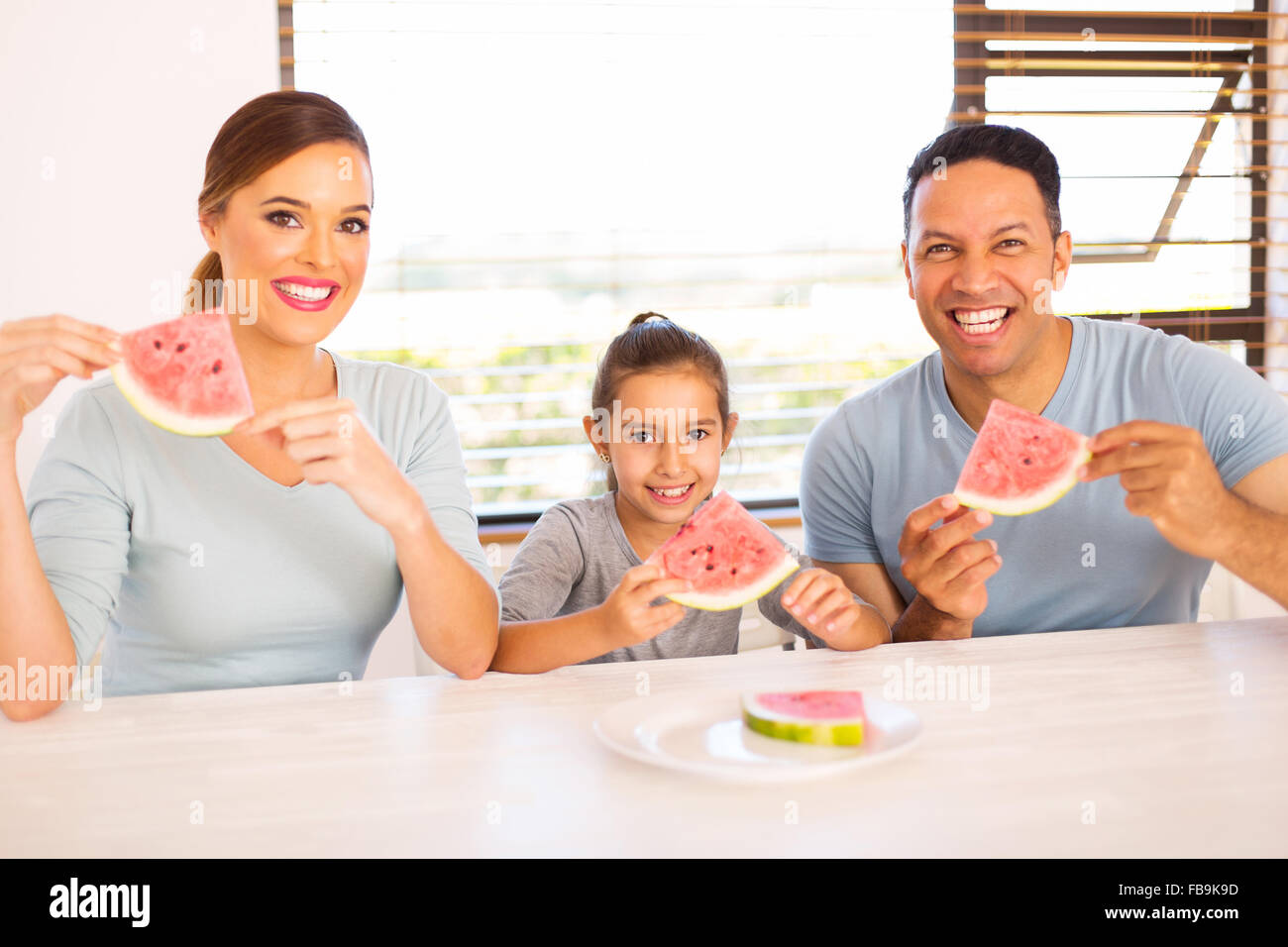 portrait of happy family enjoying watermelon Stock Photo - Alamy
