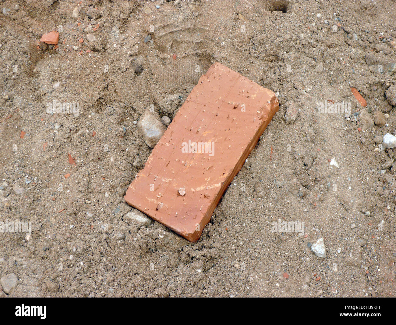 one brick on sand Stock Photo - Alamy