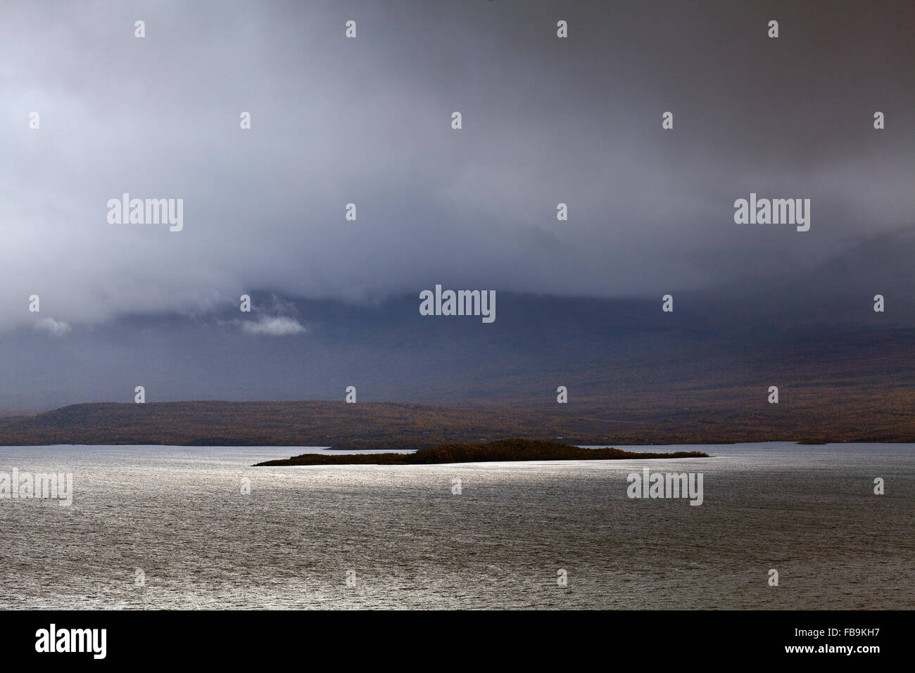 Dark and windy morning in the Nordic mountain, rainy clouds. Lake this ...