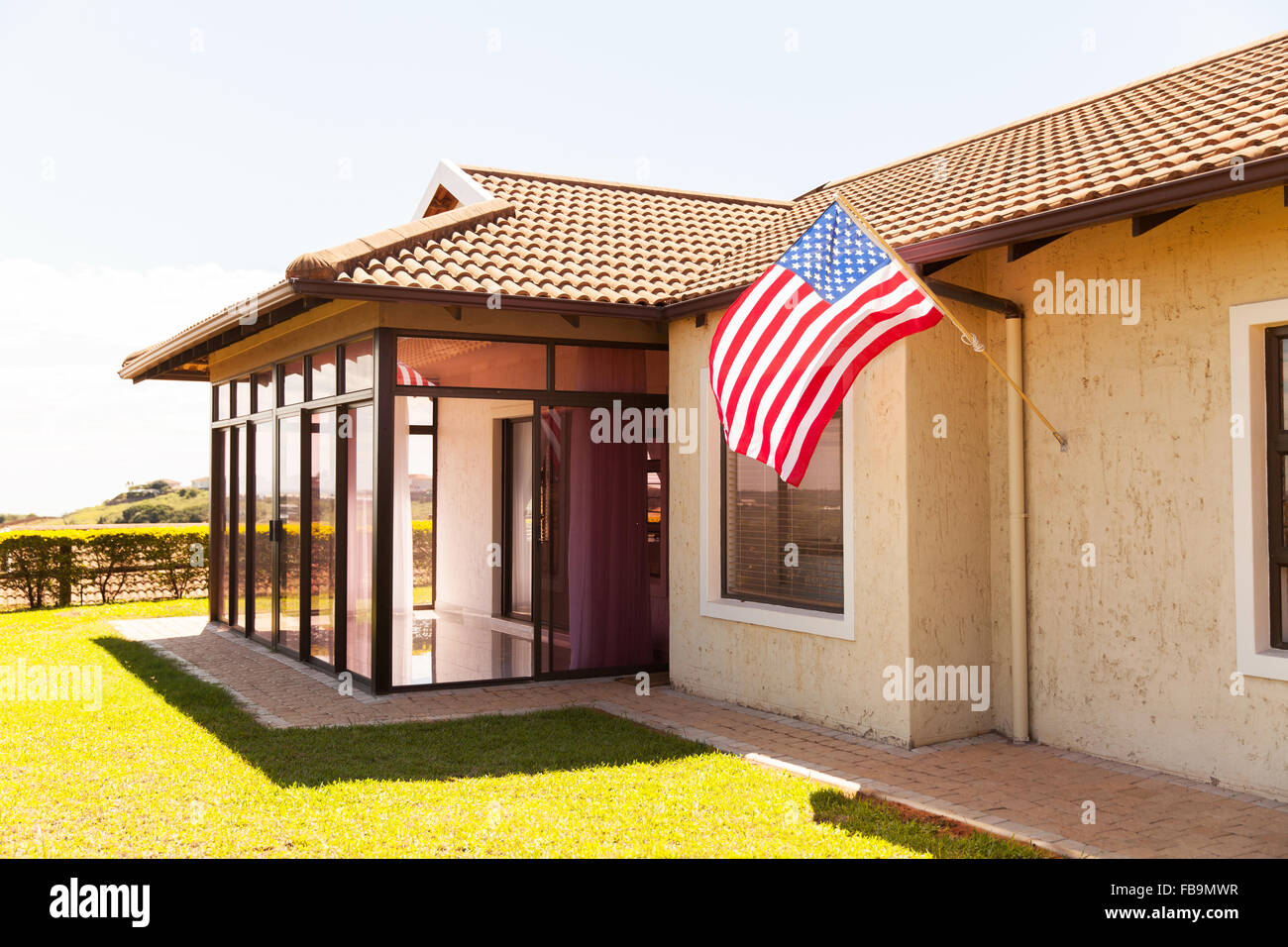 American flag front of house hi-res stock photography and images - Alamy