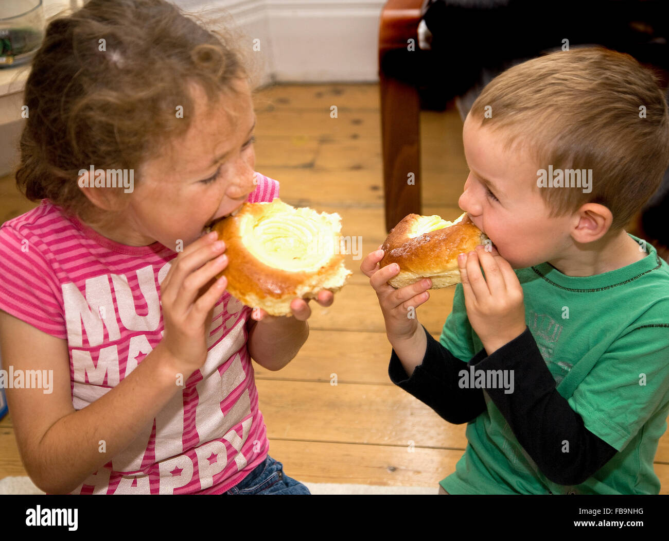 Children eating bakery sweet buns Stock Photo - Alamy