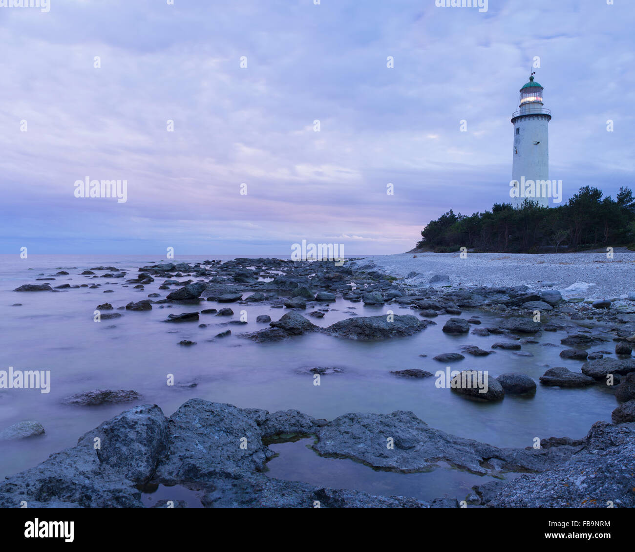 Sweden, Gotland, Faro, Lighthouse at dusk under romantic sky Stock ...