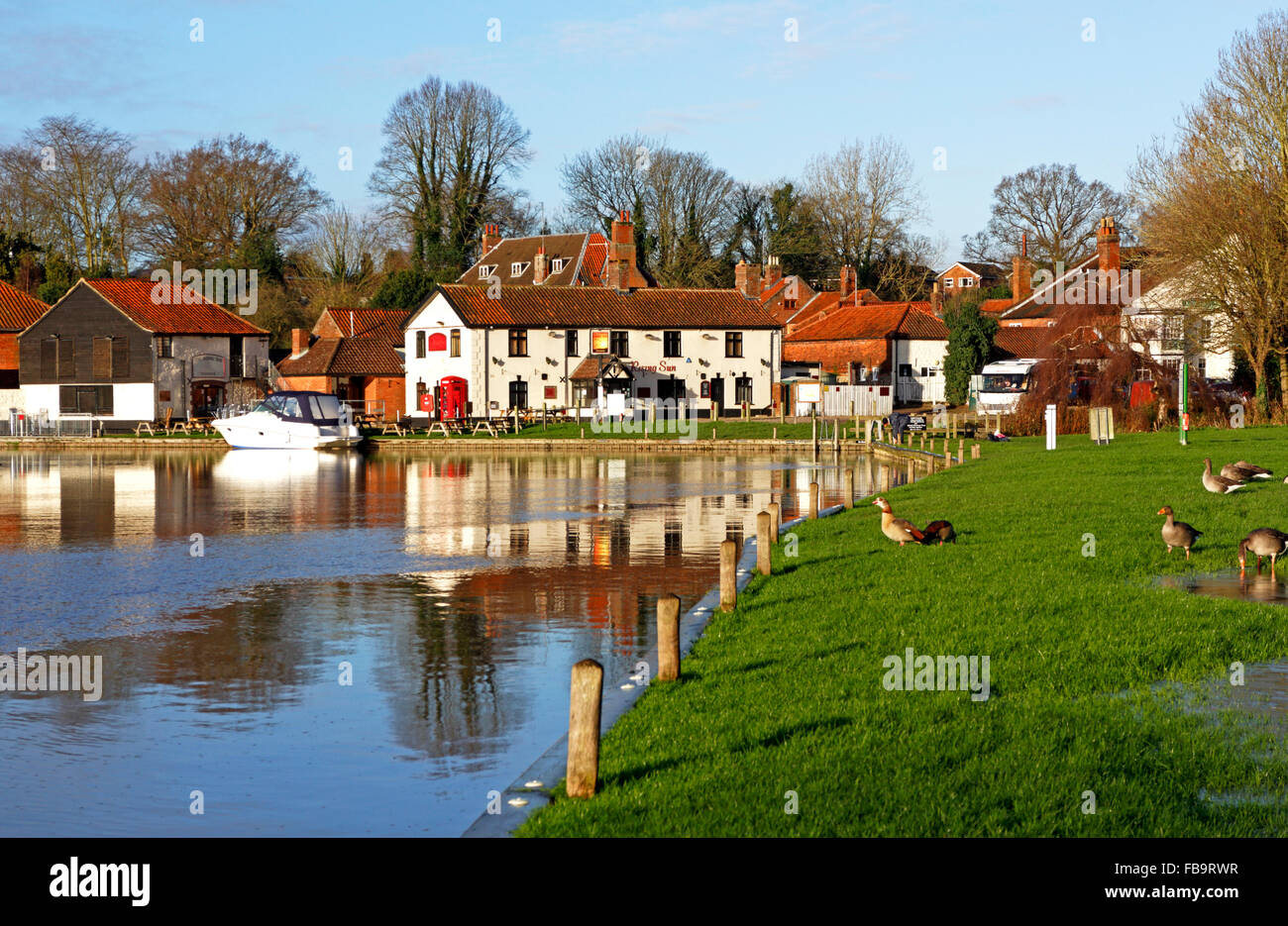 A view of a bend in the River Bure with the Rising Sun public house on ...