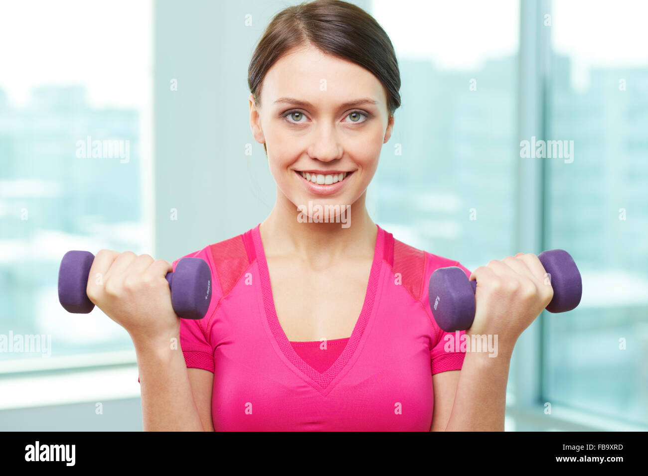 Young pretty woman exercising with dumbbells Stock Photo - Alamy