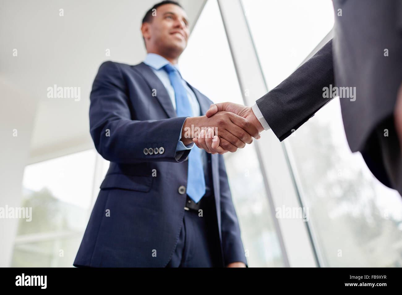Businessmen shaking hands at the office Stock Photo - Alamy