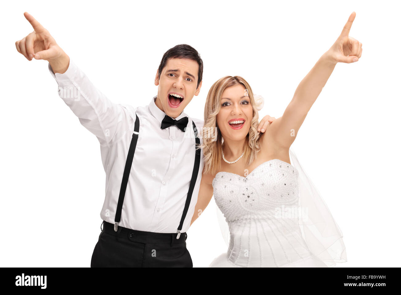 Joyful bride and groom singing together and pointing up with their ...