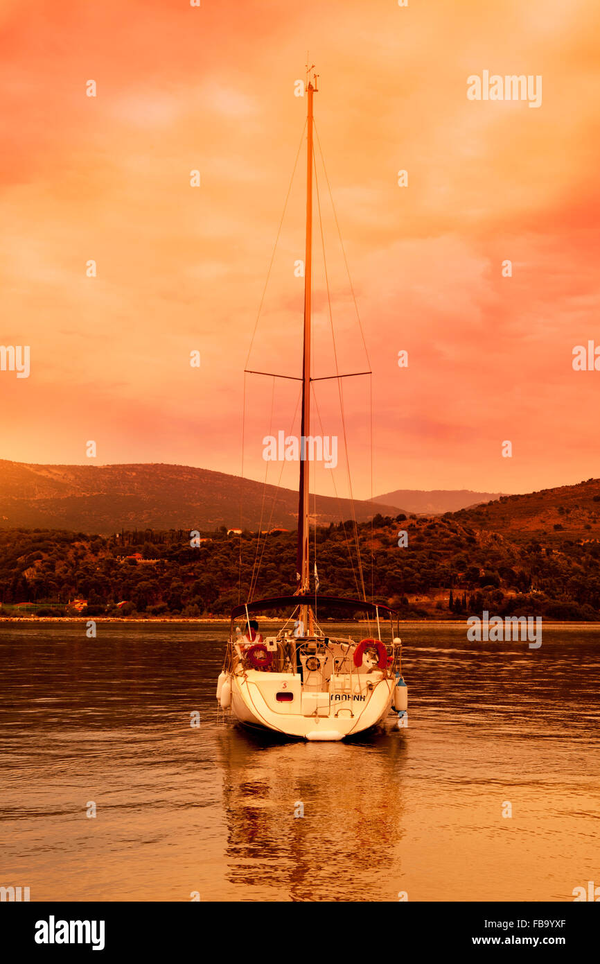 Sunset sailing boat in peaceful waters Stock Photo - Alamy