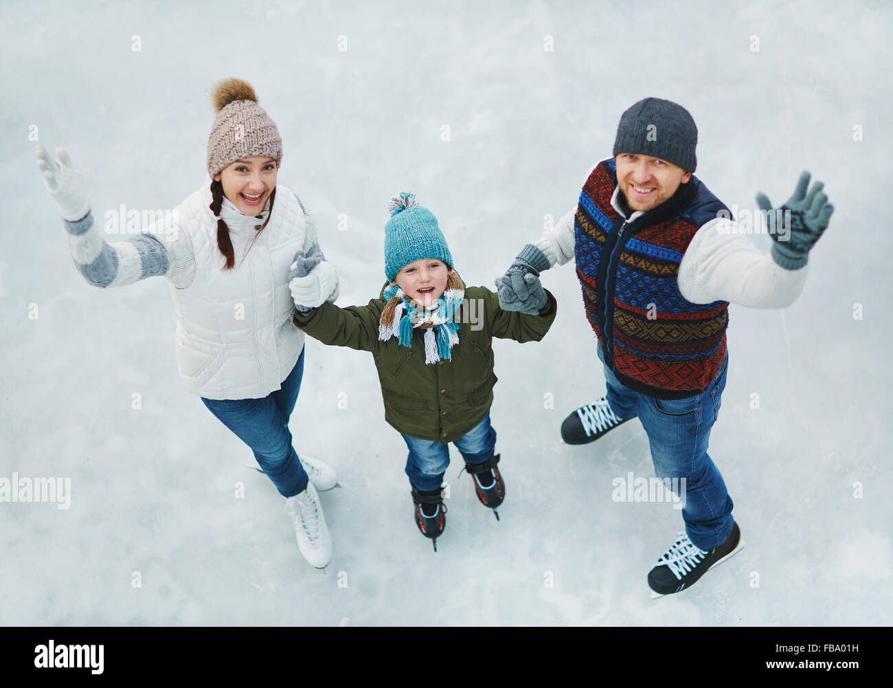 Family portrait of three people in skating rink Stock Photo - Alamy