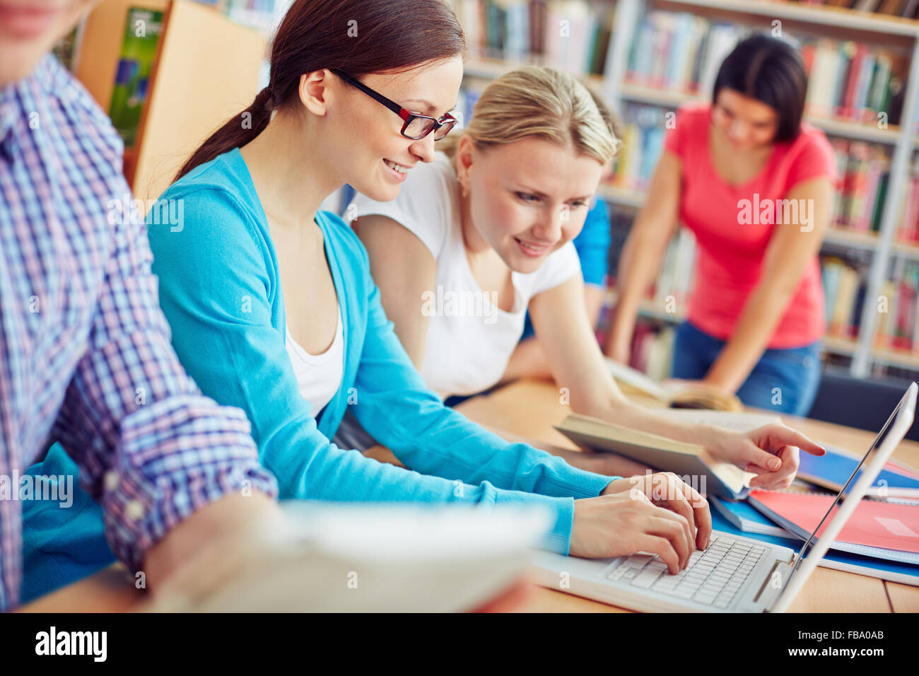College students using laptop together Stock Photo - Alamy