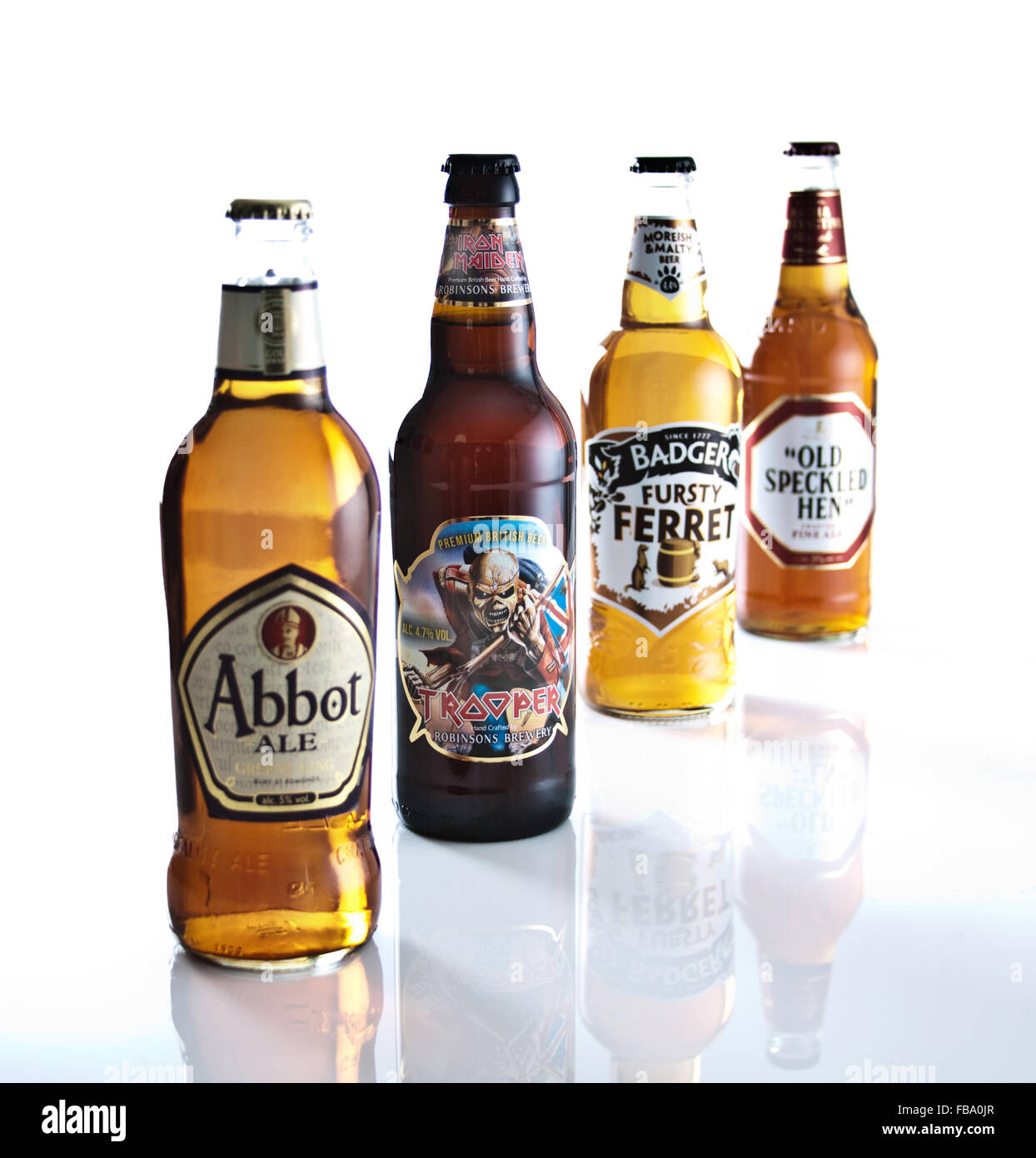 Four colourful beer bottles arranged to show depth of field and ...