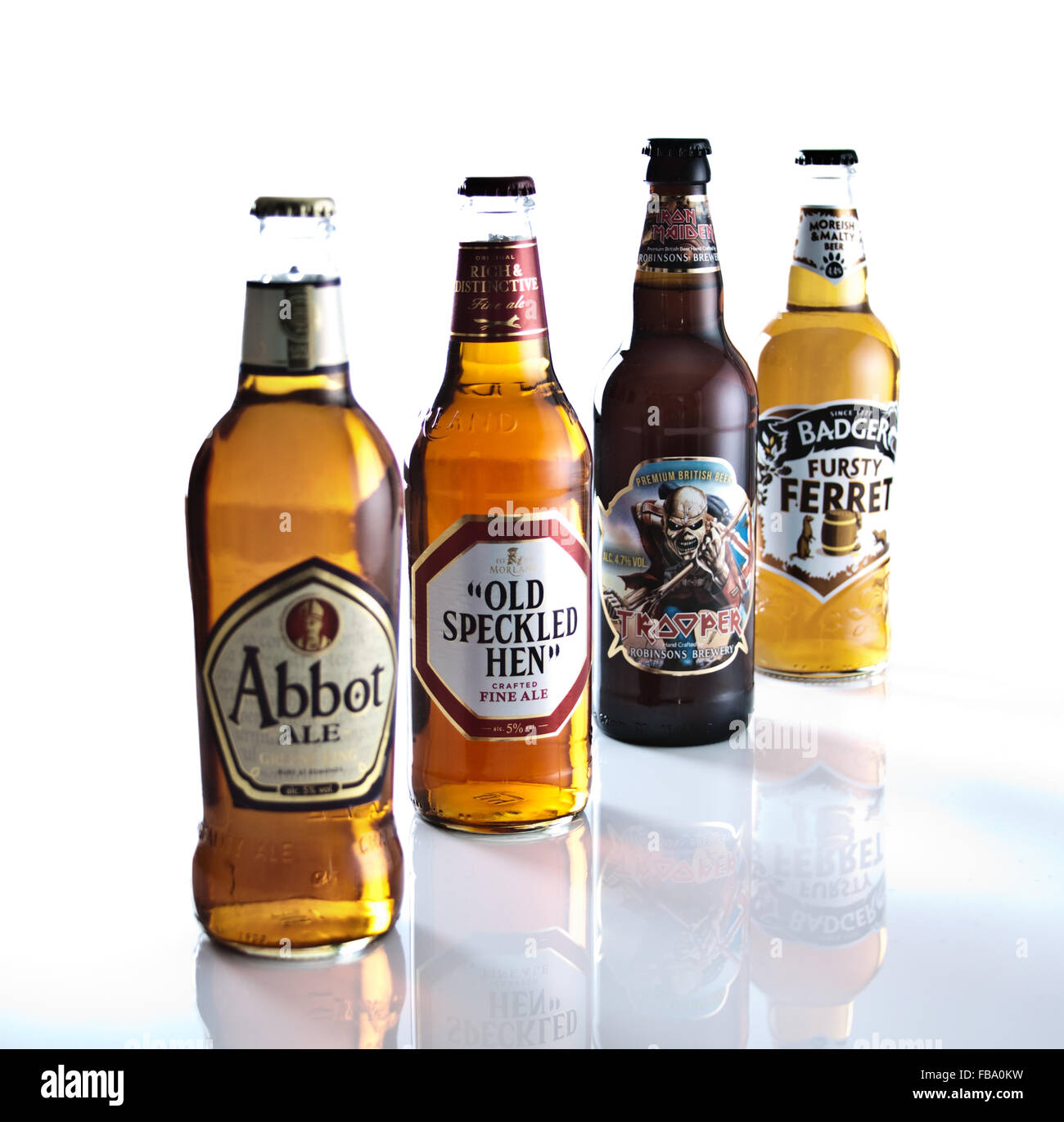 Four colourful beer bottles arranged to show depth of field and ...