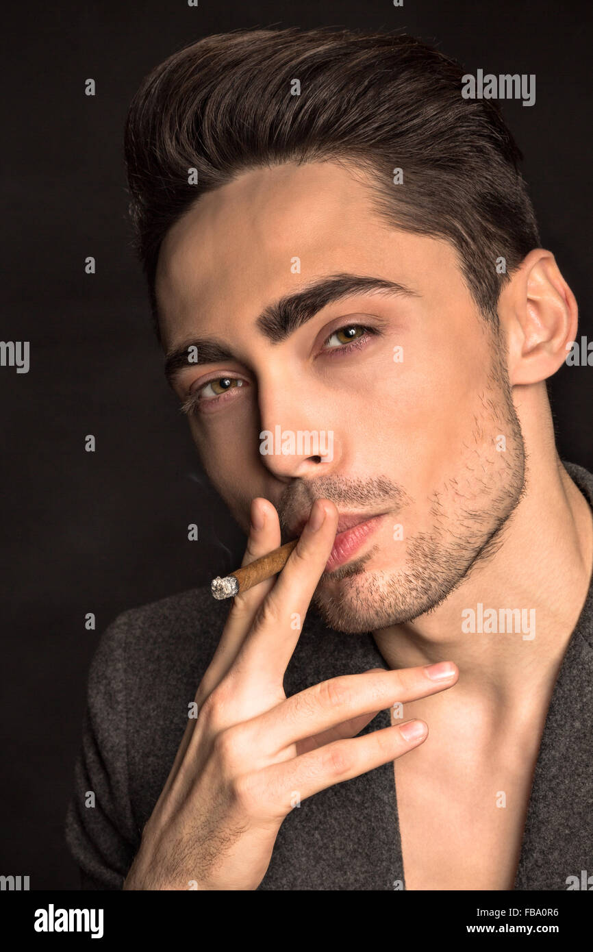 Model man smoking in studio Stock Photo - Alamy