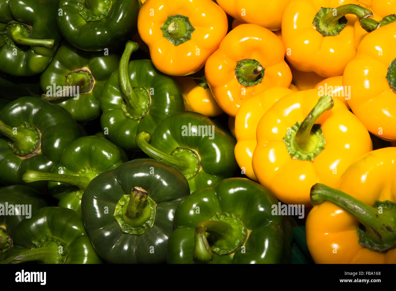 A grocers shop display of Green and Yellow Bell Peppers Stock Photo - Alamy