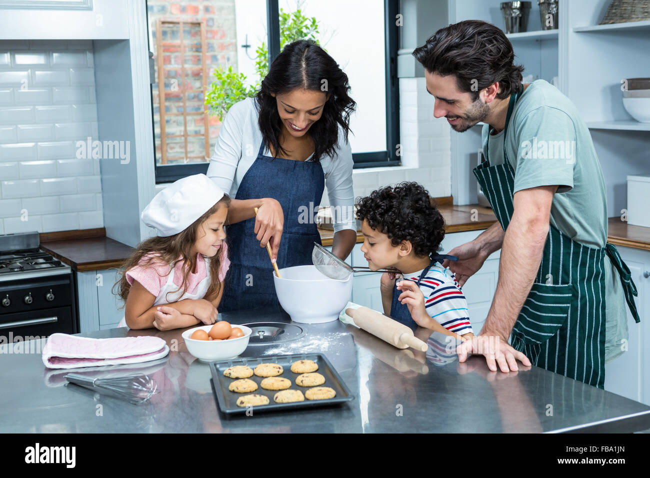 Happy family cooking biscuits together Stock Photo - Alamy
