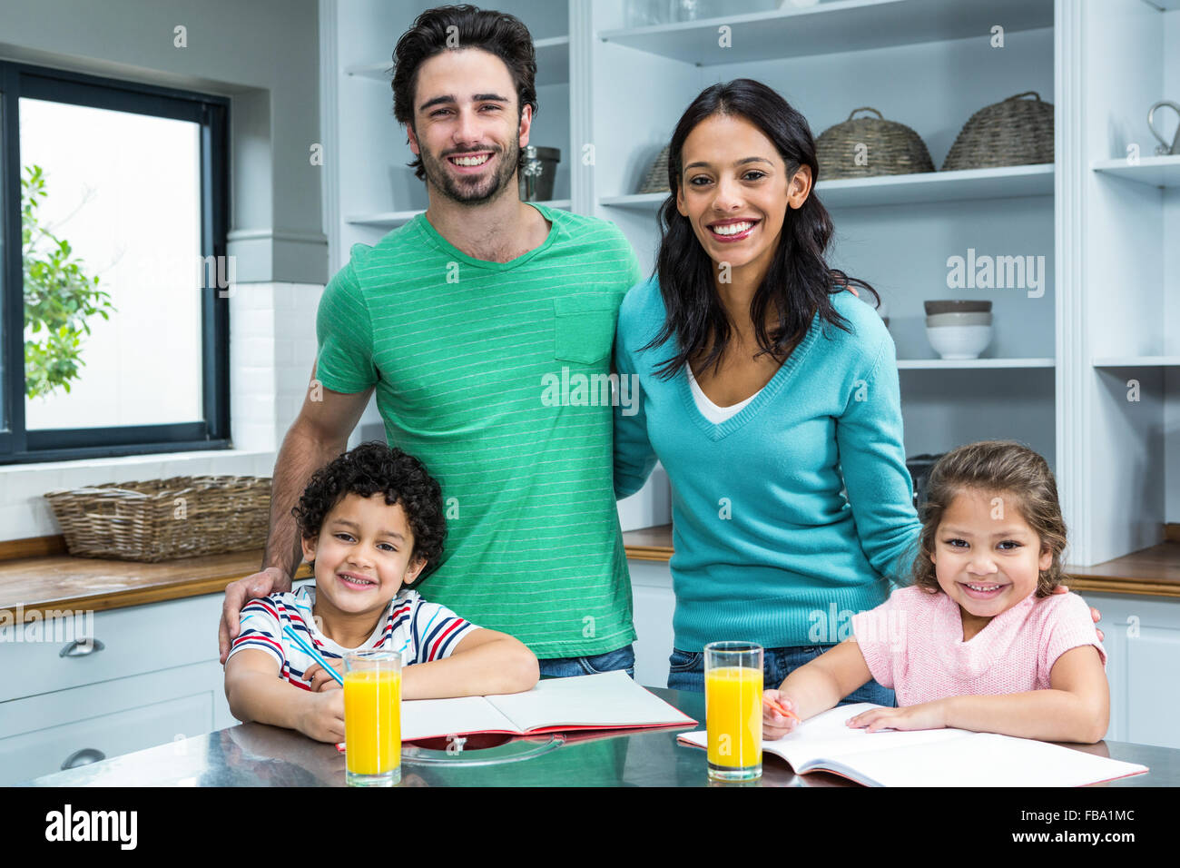 Smiling family in the kitchen Stock Photo - Alamy