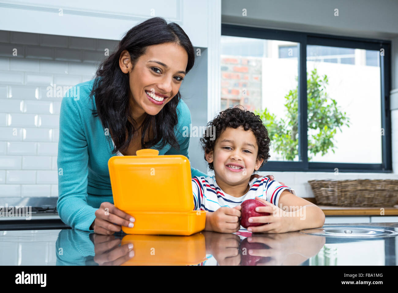 Smiling mother and son going to eat an apple Stock Photo - Alamy