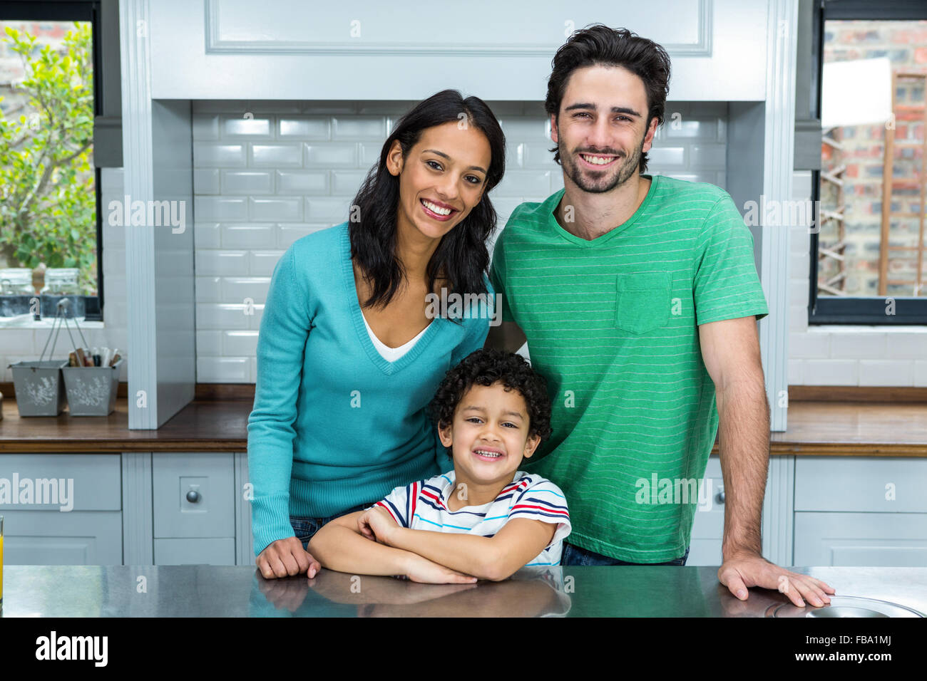 Smiling family in the kitchen Stock Photo - Alamy