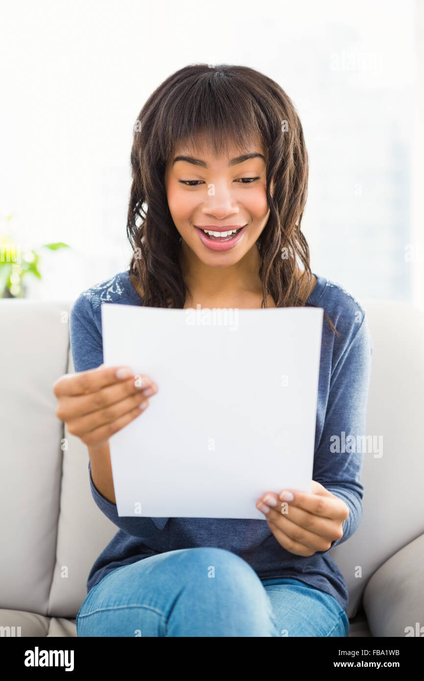 Casual smiling woman reading paper Stock Photo - Alamy